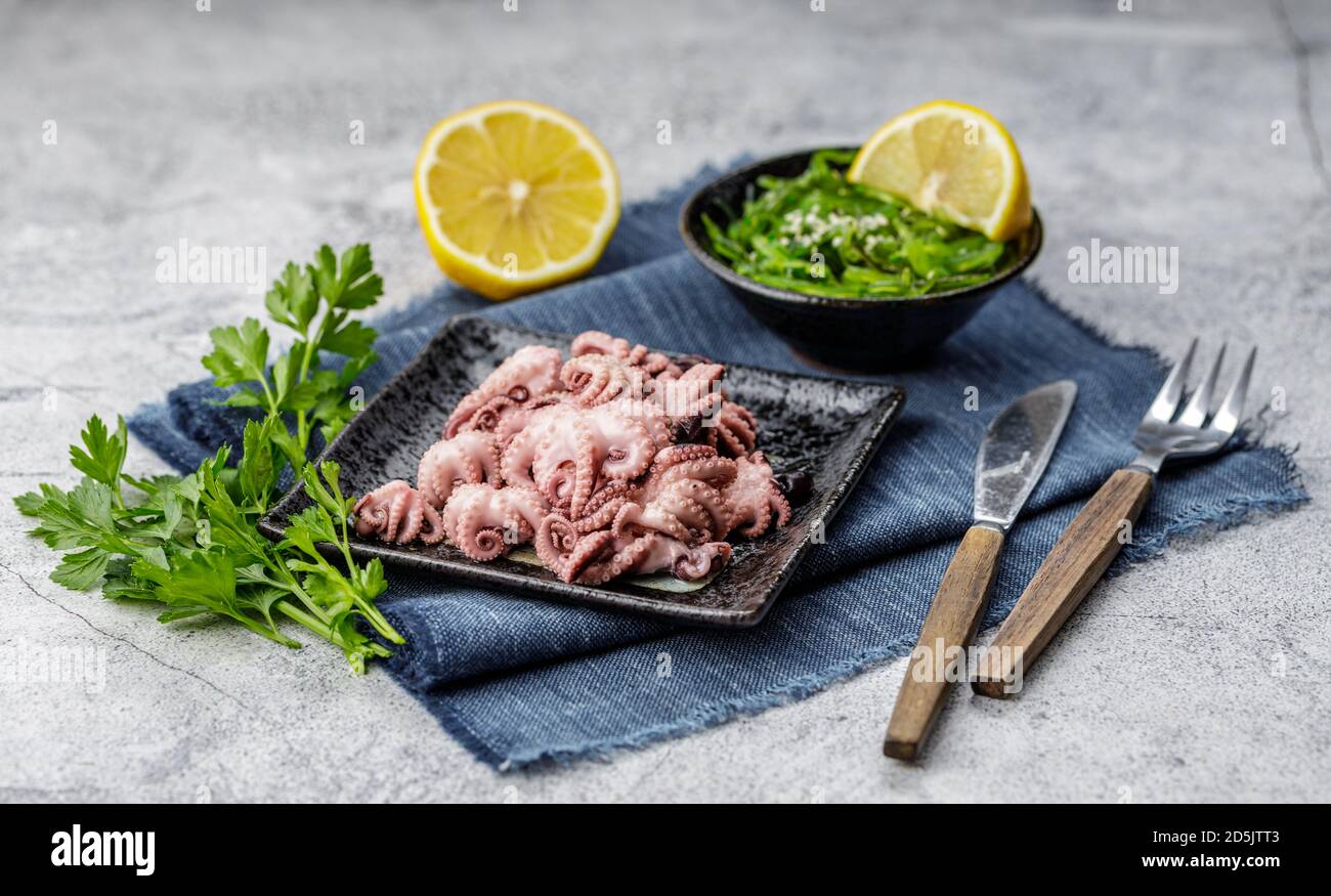Traditional asian food. Delicious boiled octopus with fresh wakame ...