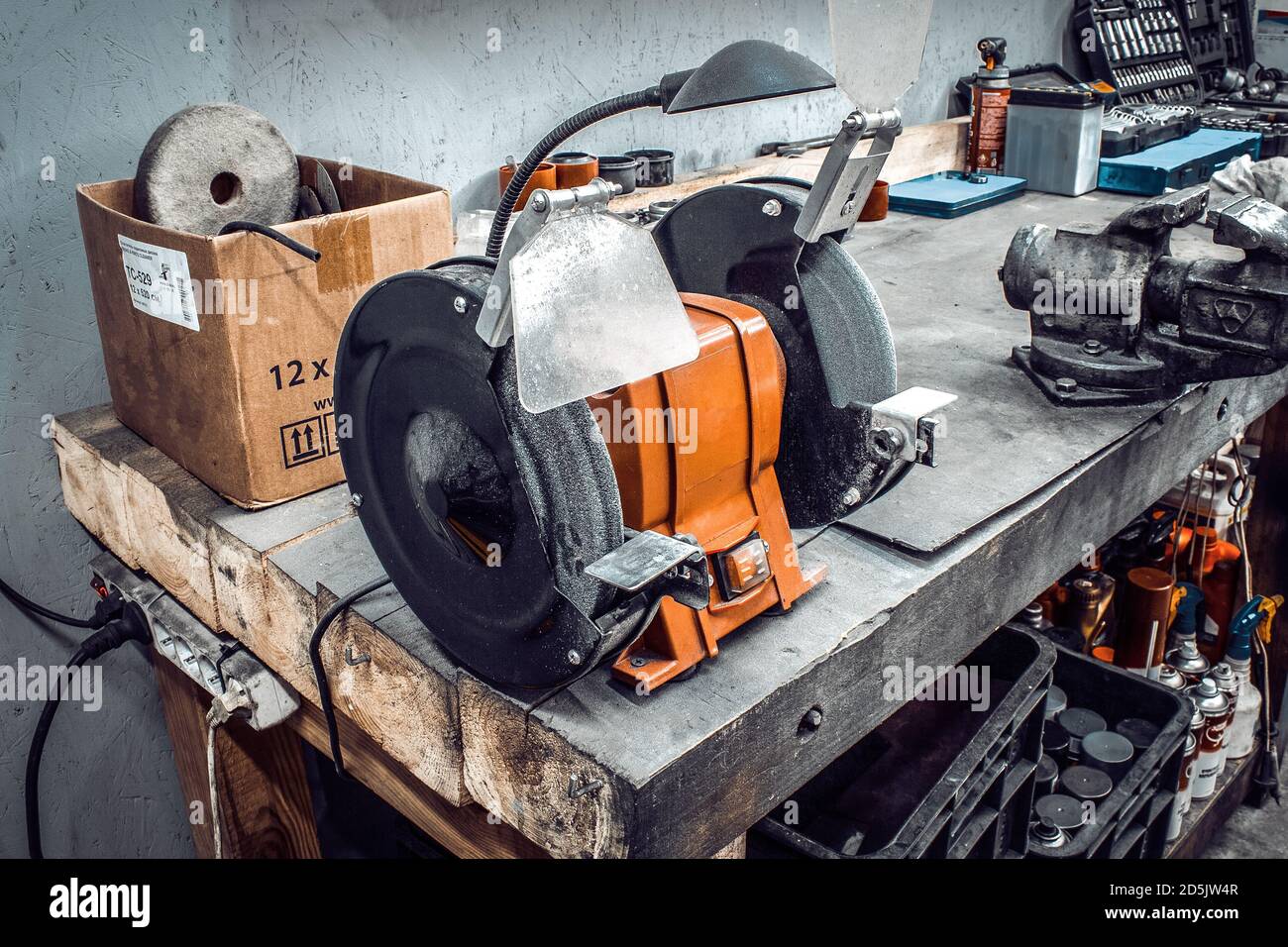 Sander machine on a large workbench, with a vice and a professional set ...