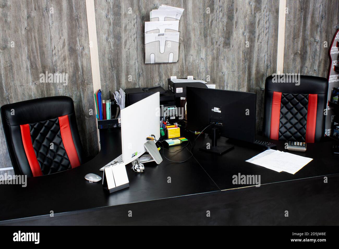 Workspace in office with computers. Monitors on black tables with ...