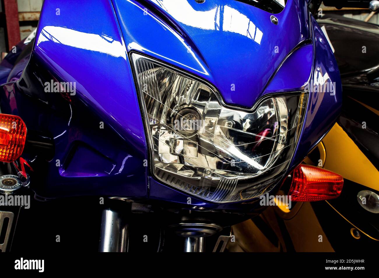 headlight of a sports motorcycle. Closeup photo in front. Shiny ...