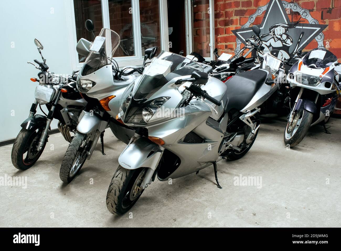 Gray sports beautiful bikes in a motor show. Many motorcycles parked in ...