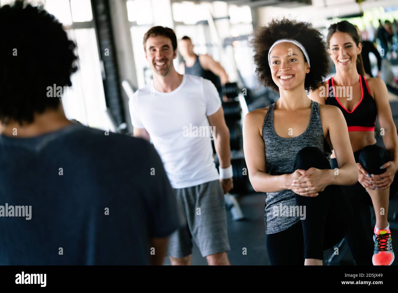 Beautiful fit people exercising together in gym Stock Photo - Alamy