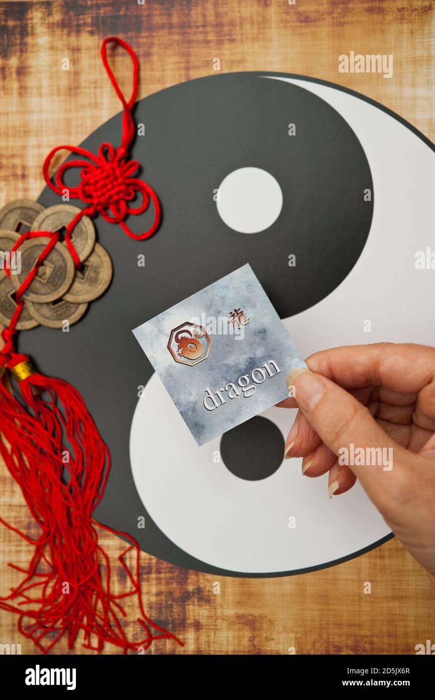 hand holding a card with the Chinese astrology sign of Dragon Stock ...