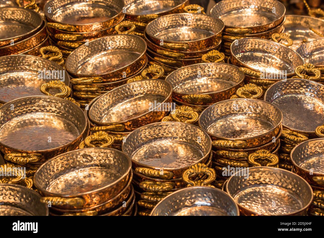 Closeup shot of a lot of ancient golden pans in an antique store Stock ...
