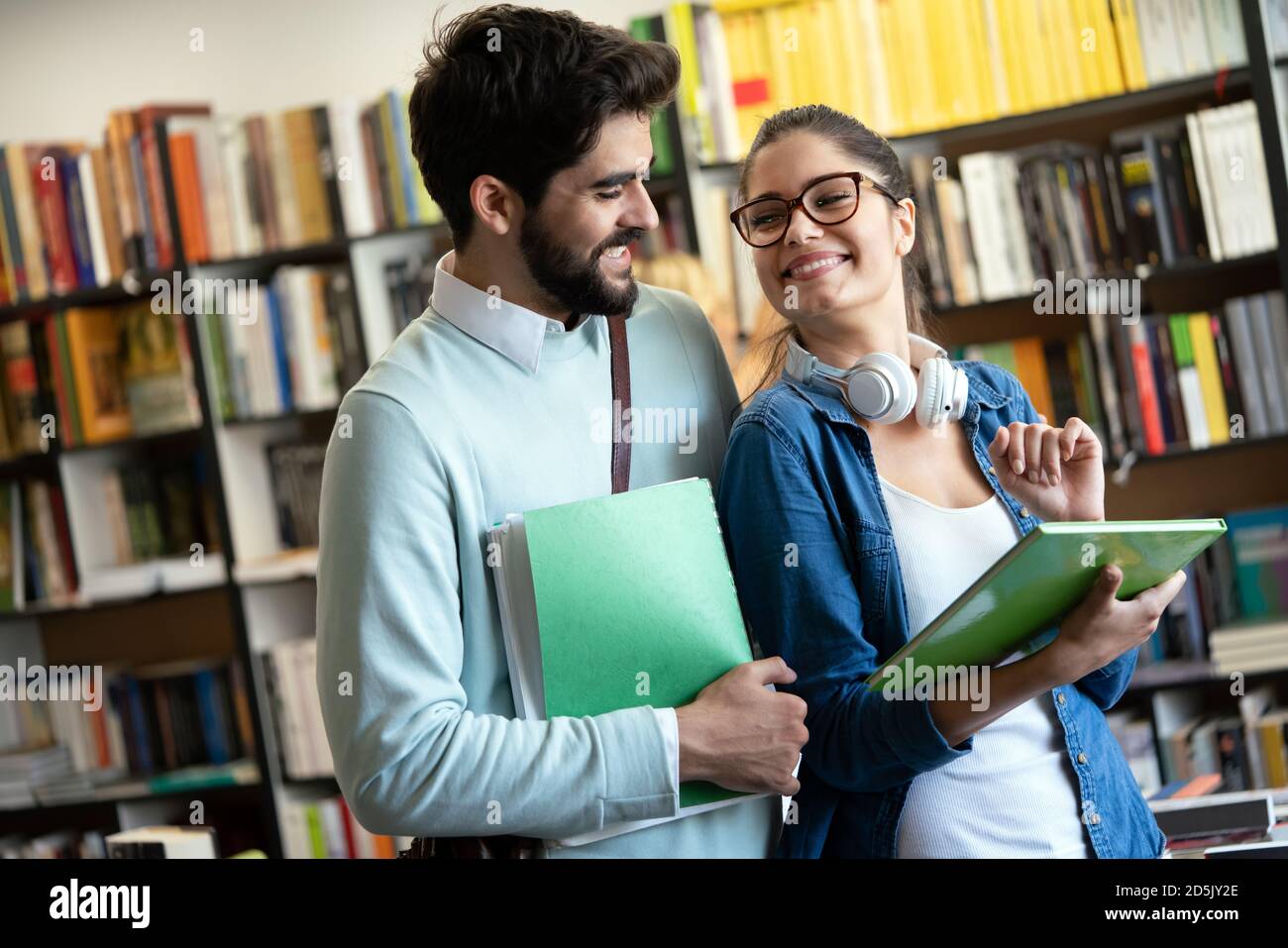 Happy group of students studying and working together in a college ...