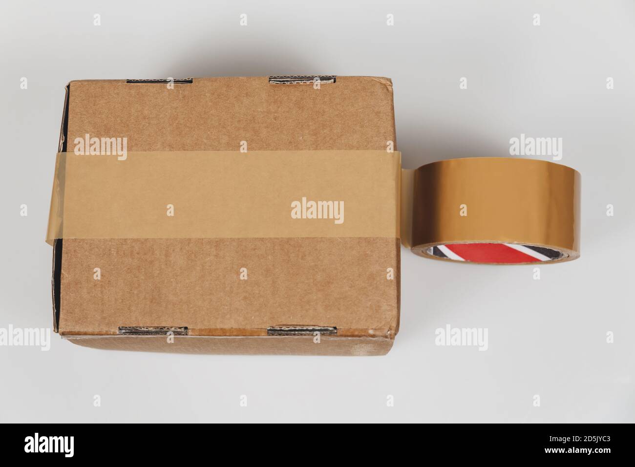 Closeup shot of closing a box with a duct tape Stock Photo - Alamy
