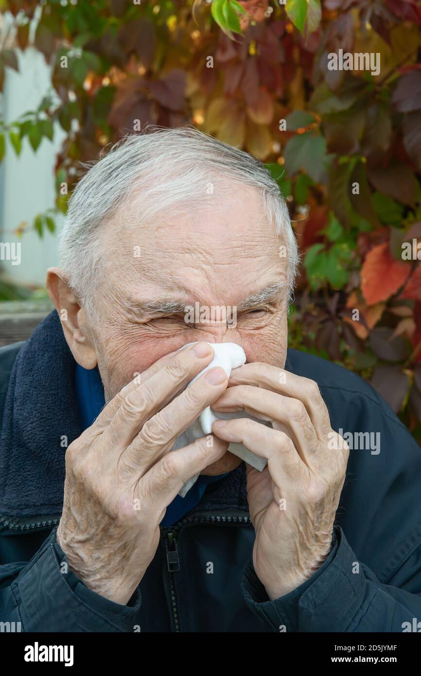 old man wipes his tears with a handkerchief. Upset distressed sick old ...