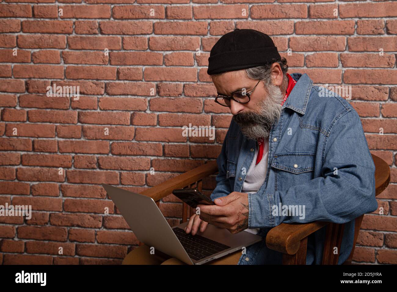 Side view portrait of cheerful bearded brunette man in denim shirt ...