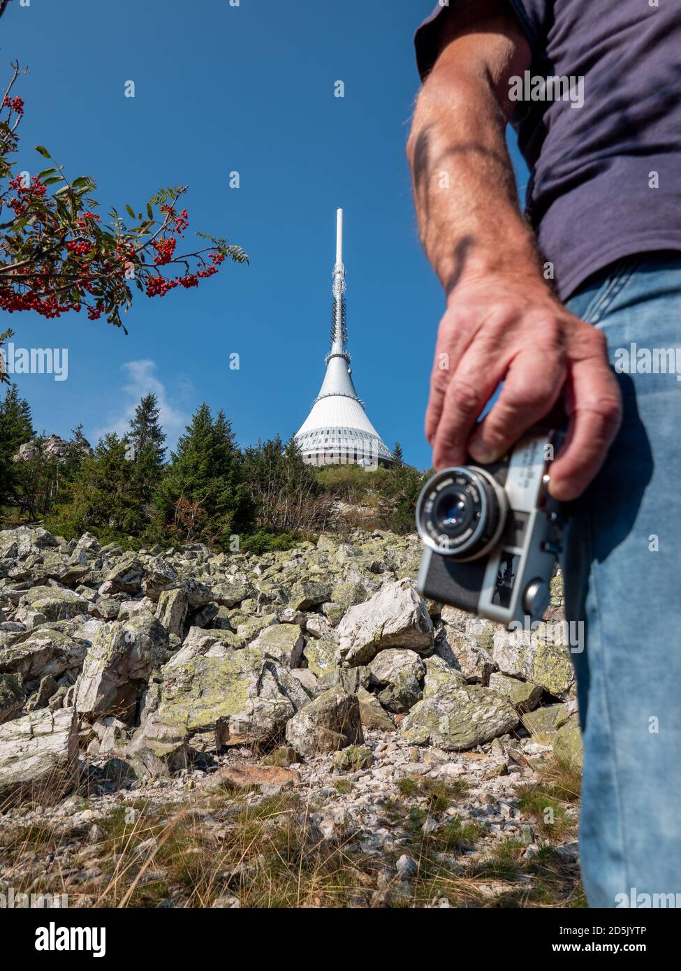 Old man hand hold analog Minolta camera and Jested mountain. 16th of ...