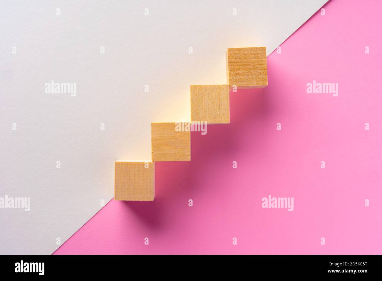 Wooden square block on pink and white background Stock Photo - Alamy