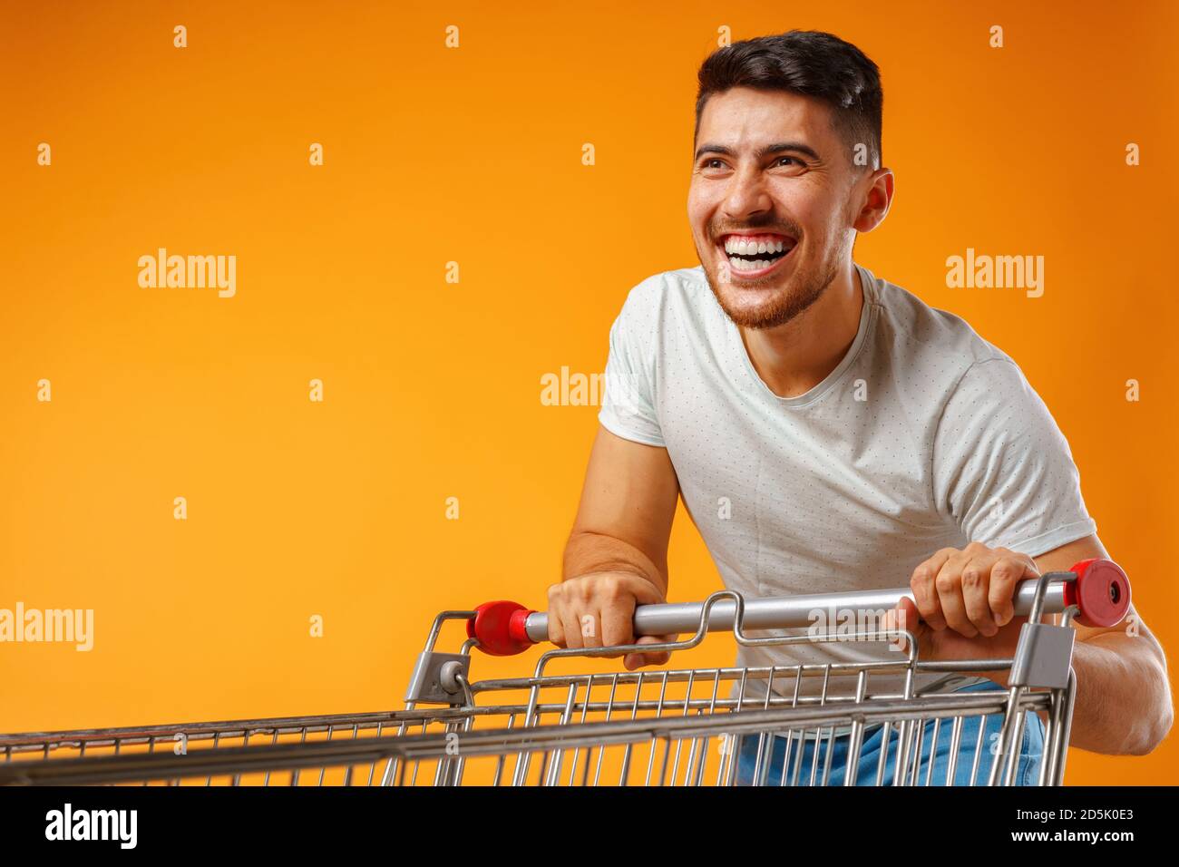 Funny crazy man rushing with shopping trolley to sale Stock Photo - Alamy