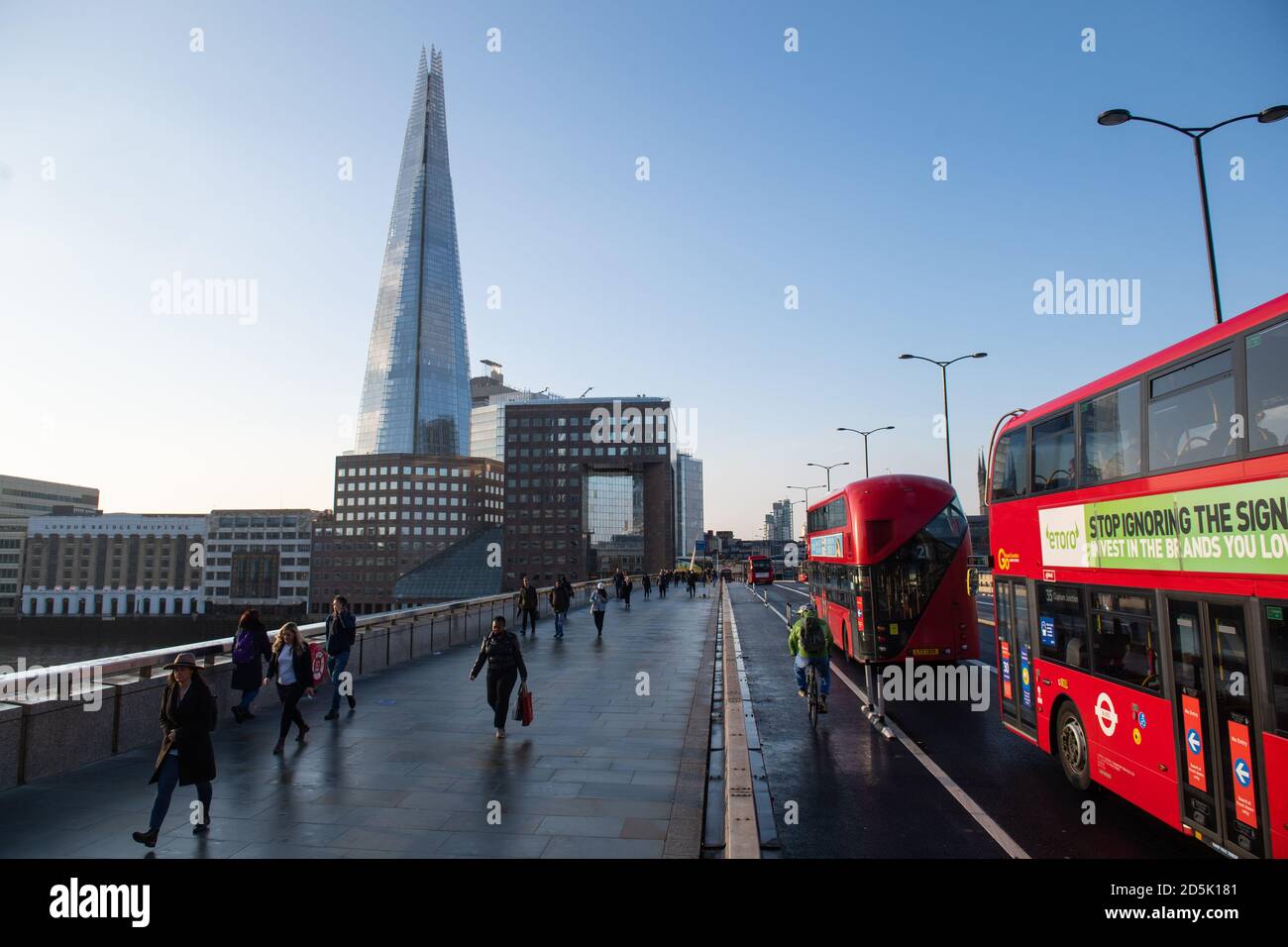 Commuters cross London Bridge, in central London, during morning rush ...