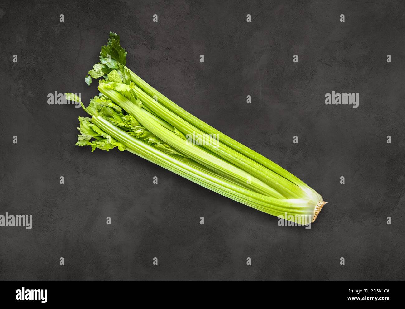 Celery branch bunch on a concrete background. Top view Stock Photo - Alamy