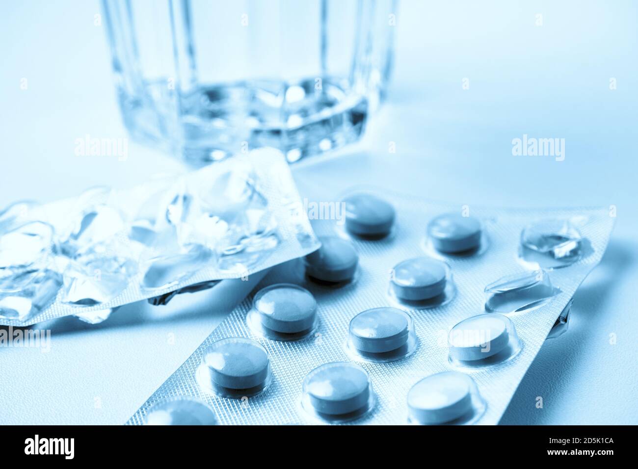 A glass of water with medical pill plates Stock Photo - Alamy