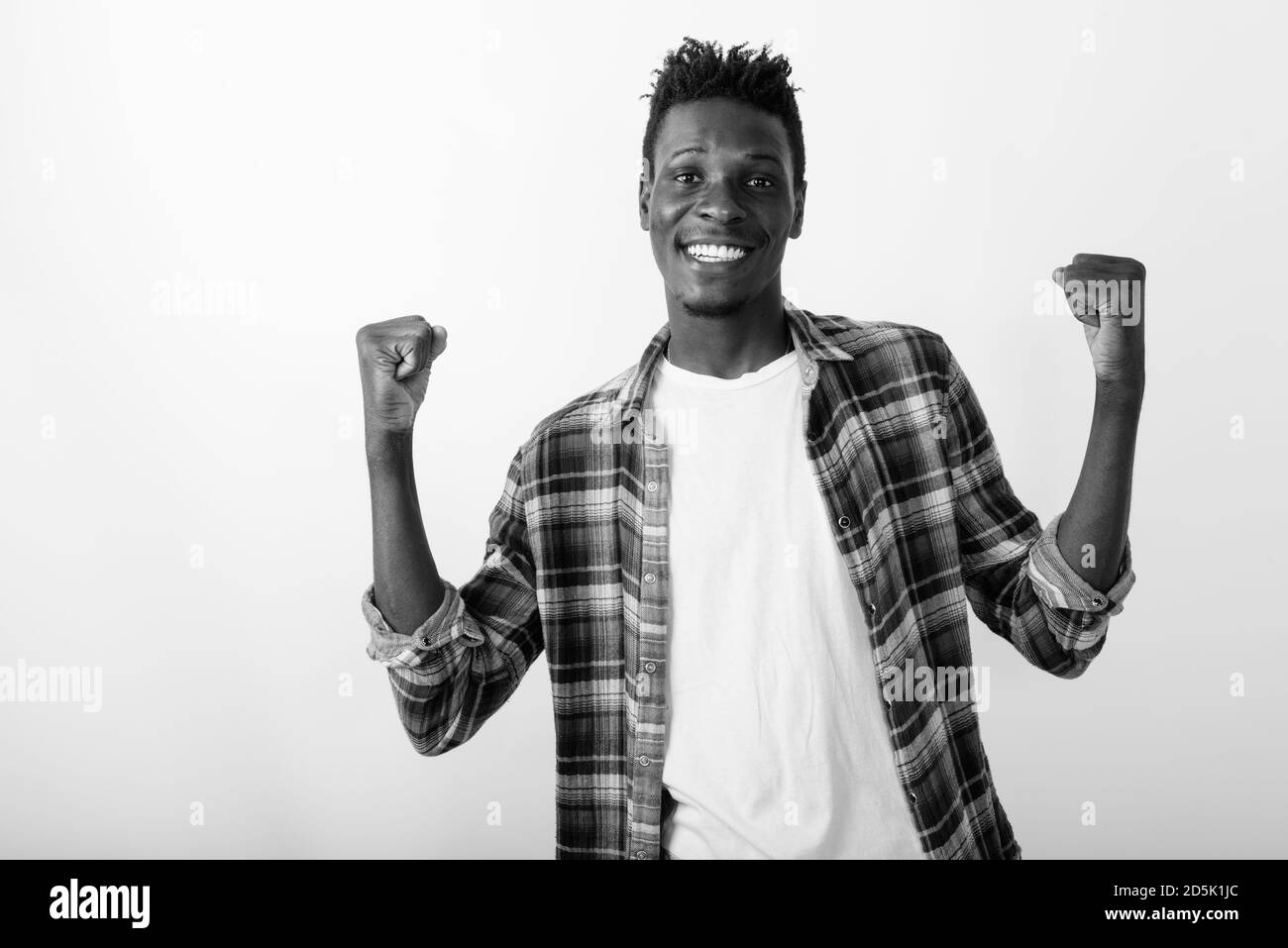 Studio shot of young happy black African man smiling while looking ...