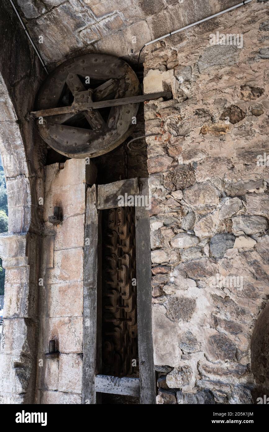 Vertical photo of a rusty iron mechanism in a stone door of a medieval ...