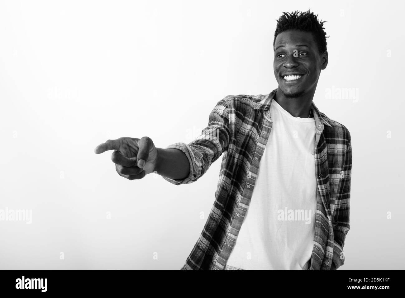 Portrait of happy young handsome African man pointing finger Stock ...