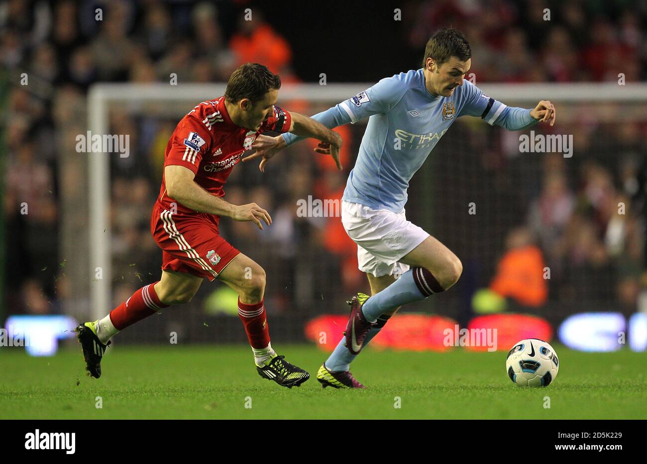 Manchester City's Adam Johnson (right) gets away from Liverpool's Fabio ...