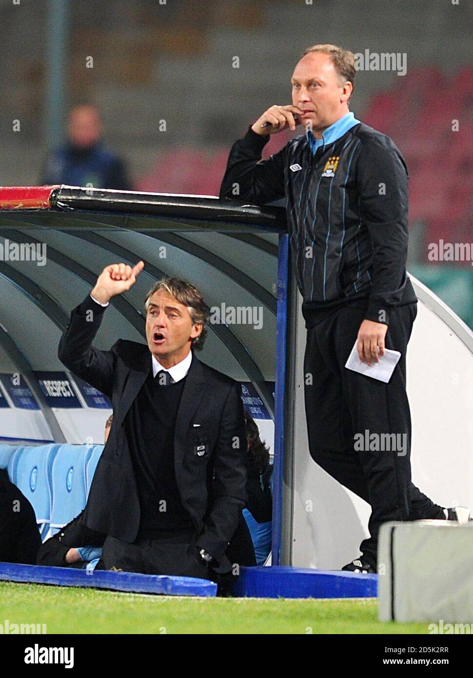 Manchester City manager Roberto Mancini (left) shouts instructions from ...