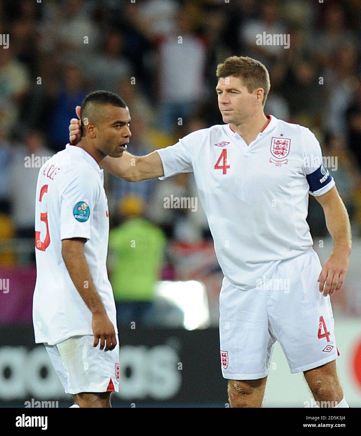 England's Ashley Cole (left) is consoled by teammate Steven Gerrard ...