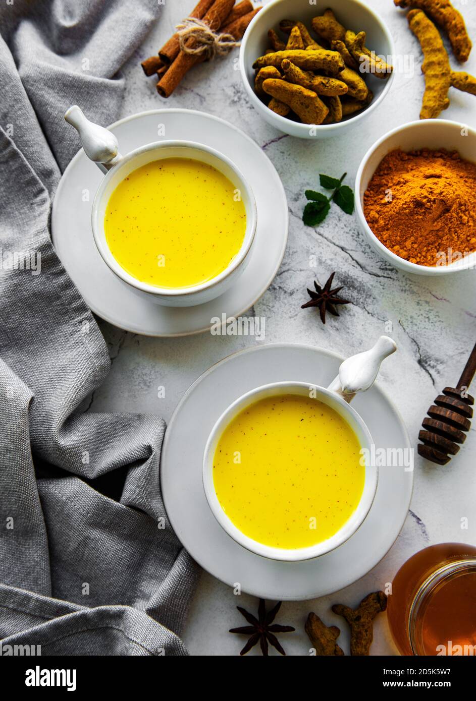Yellow turmeric latte drink. Golden milk with cinnamon, turmeric ...