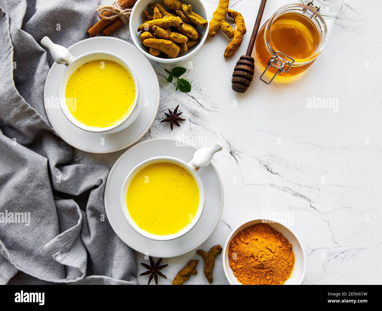 Yellow turmeric latte drink. Golden milk with cinnamon, turmeric ...