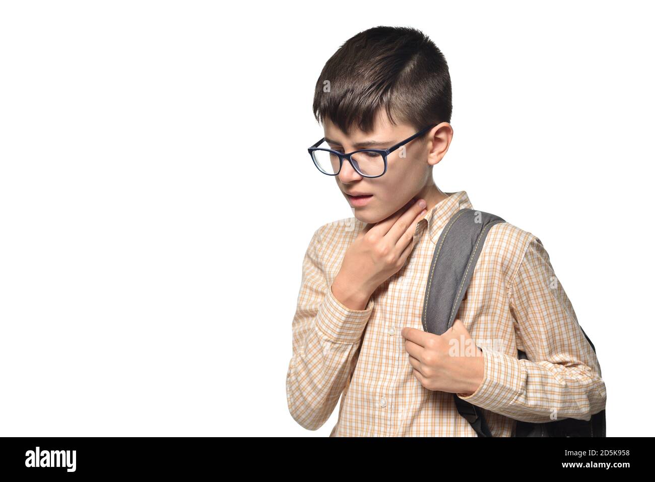 School boy sick and holding his throat on white isolated background ...