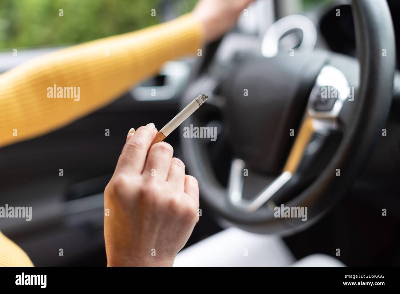 Woman smoking cigarette driving hi-res stock photography and images - Alamy