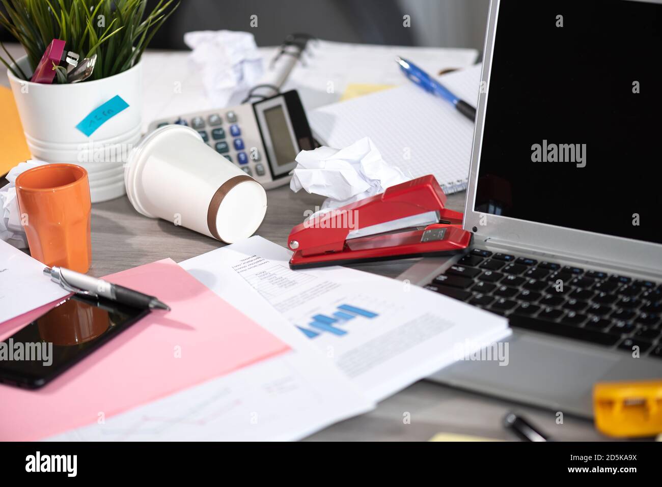 Messy and cluttered office desk Stock Photo - Alamy