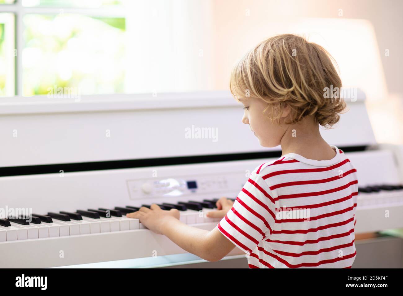 Child playing piano. Kids play music. Classical education for children ...