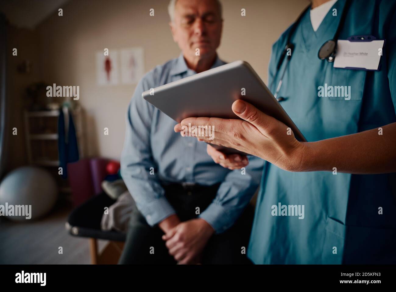 Male nurse guiding female patient hi-res stock photography and images ...