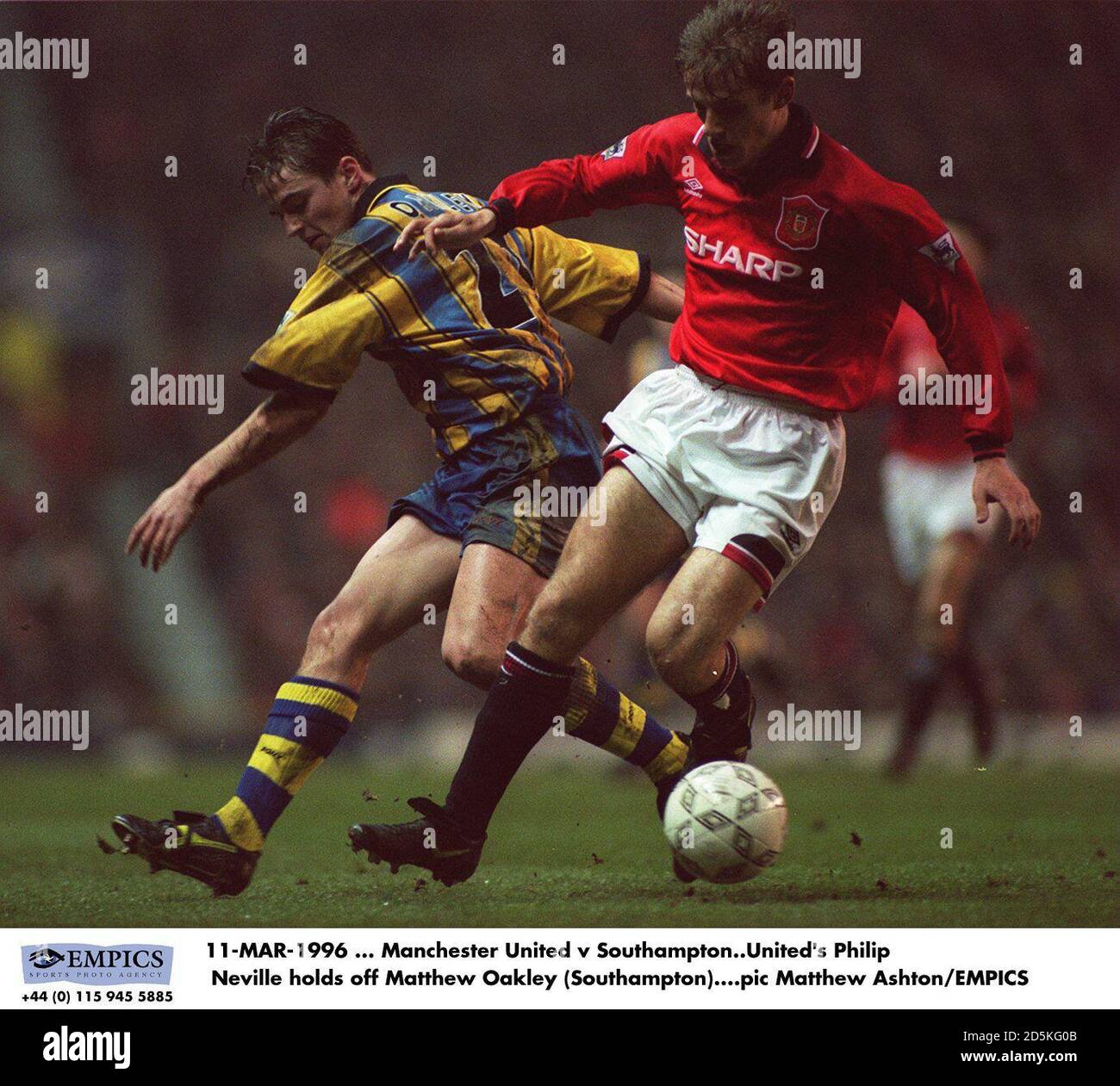 Manchester United's Philip Neville holds off Matthew Oakley ...