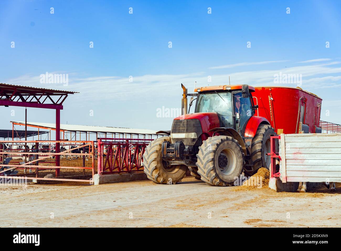 Modern red agricultural tractor in a farm Stock Photo - Alamy