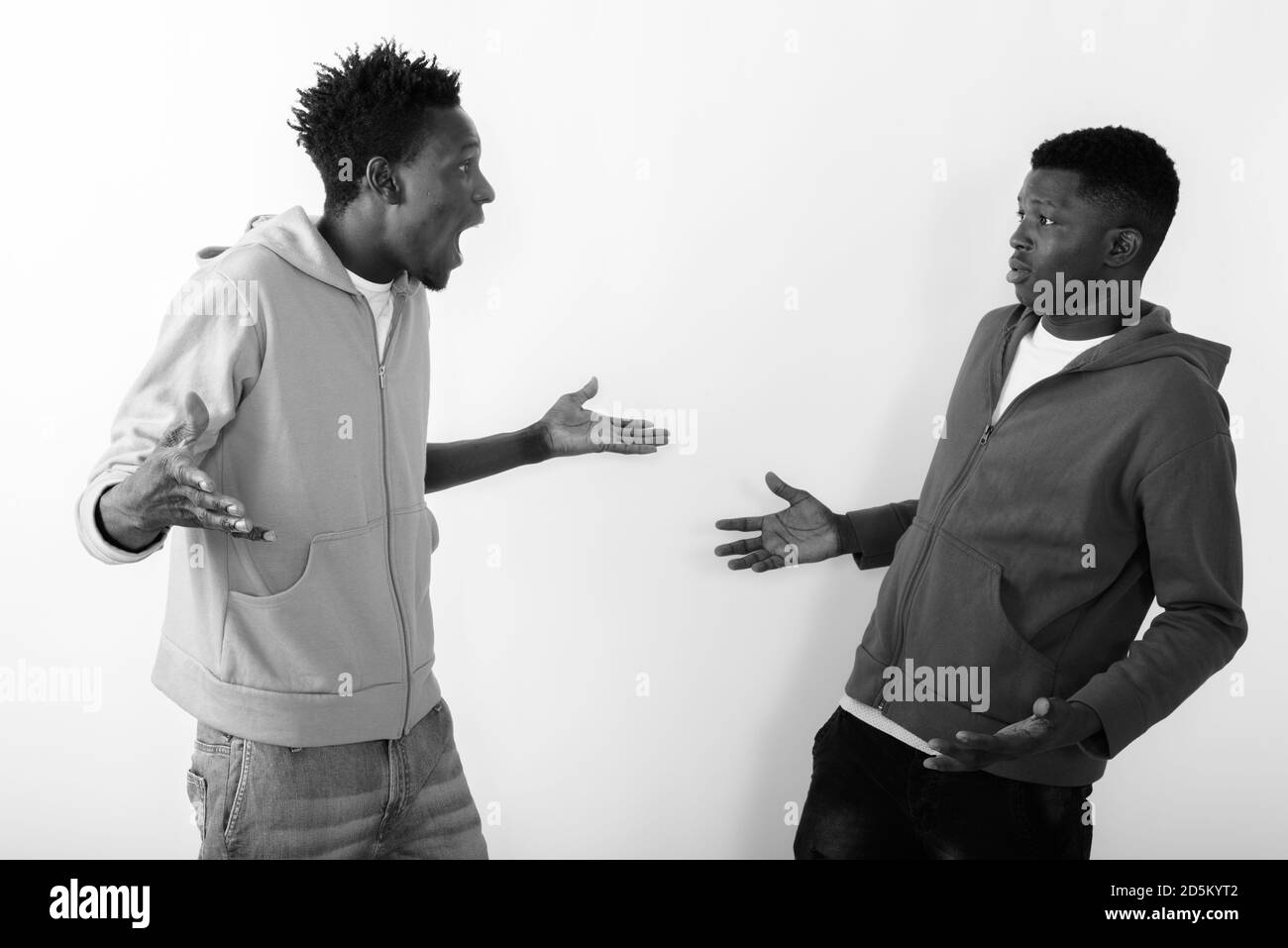 Studio shot of two young black African friends looking confused ...