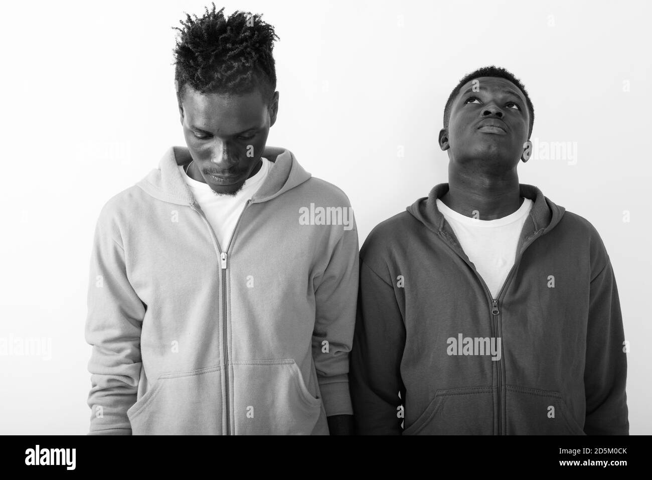 Studio shot of young African man looking up with young black African ...