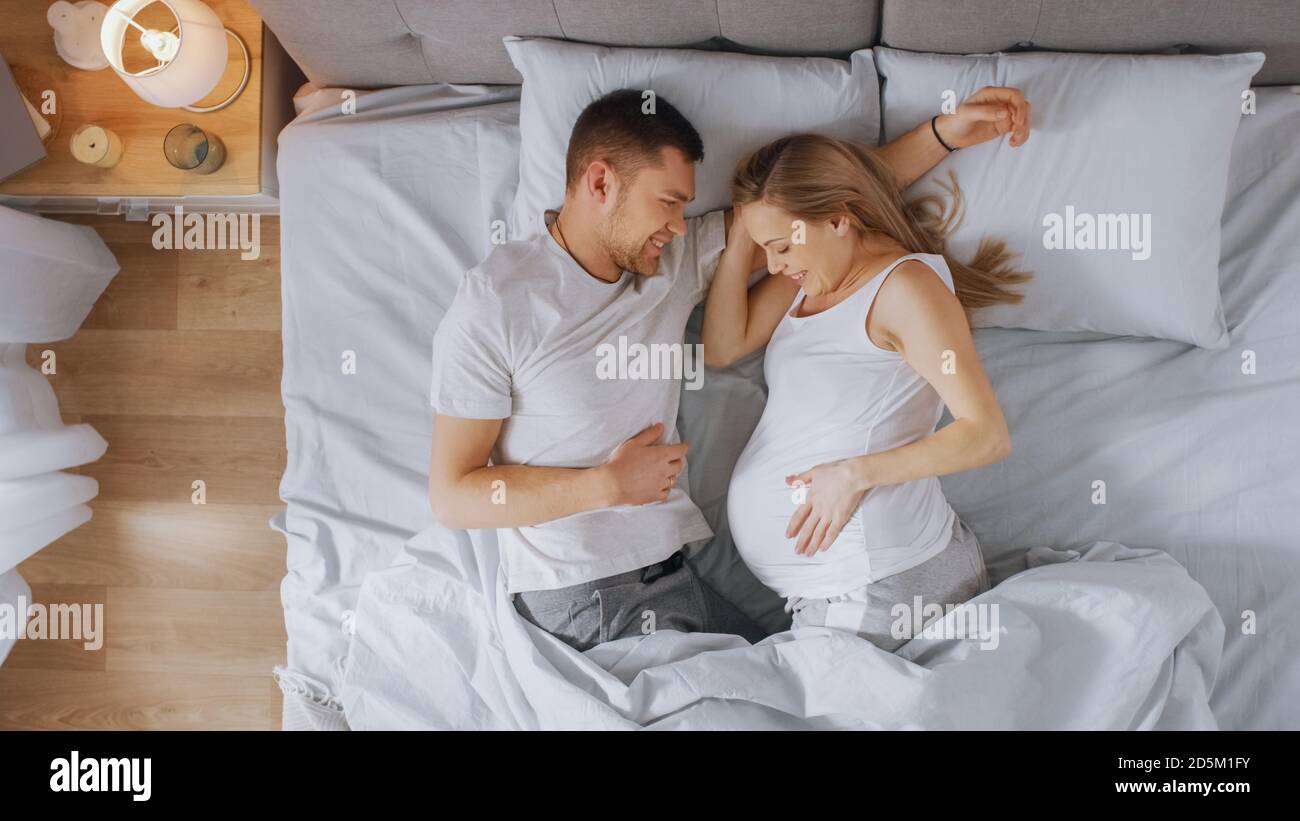 Happy Young Couple Cuddling Together in the Bed, Young Woman is ...