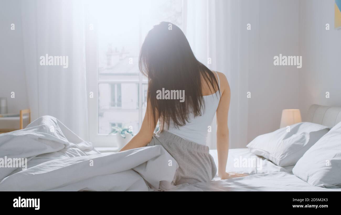 Beautiful Brunette Is Waking Up In The Morning Stretches In The Bed