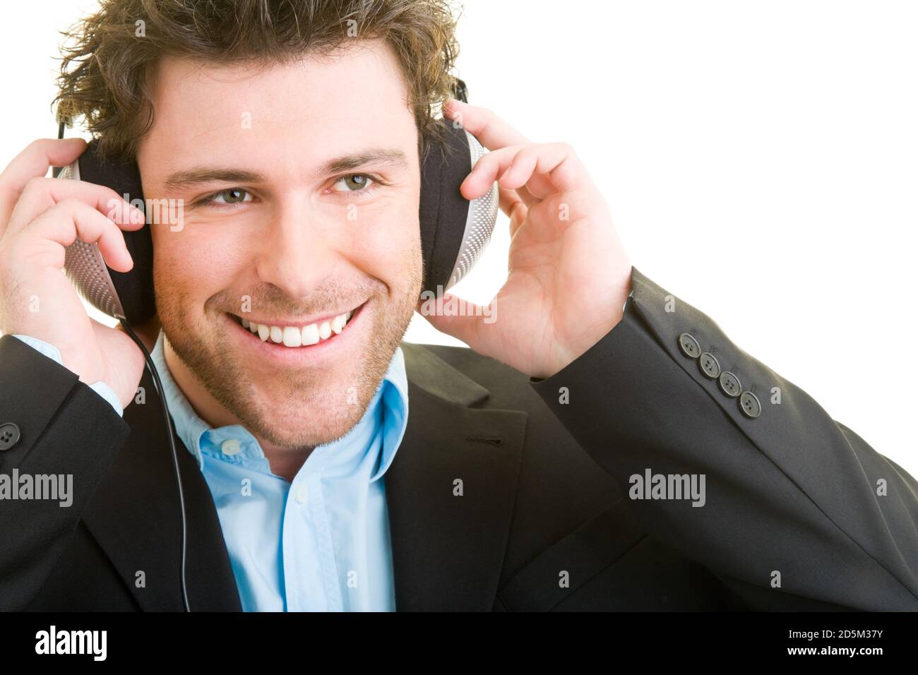 Young man in suit with headphones Stock Photo - Alamy