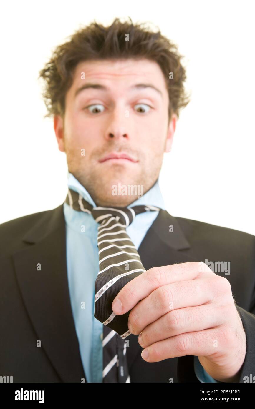 Young man in business suit has trouble tying ties Stock Photo - Alamy