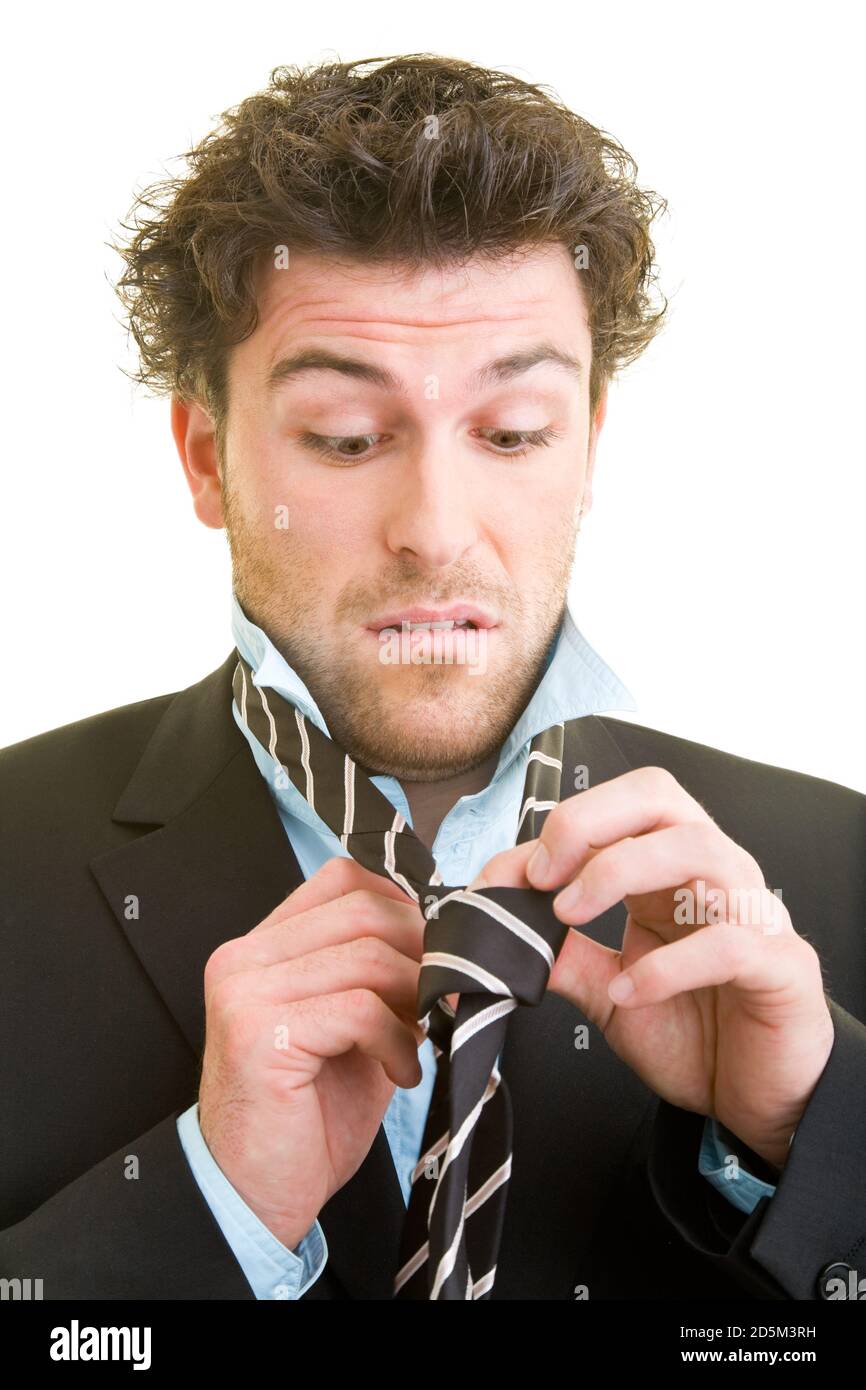 Young man in business suit has trouble tying ties Stock Photo - Alamy