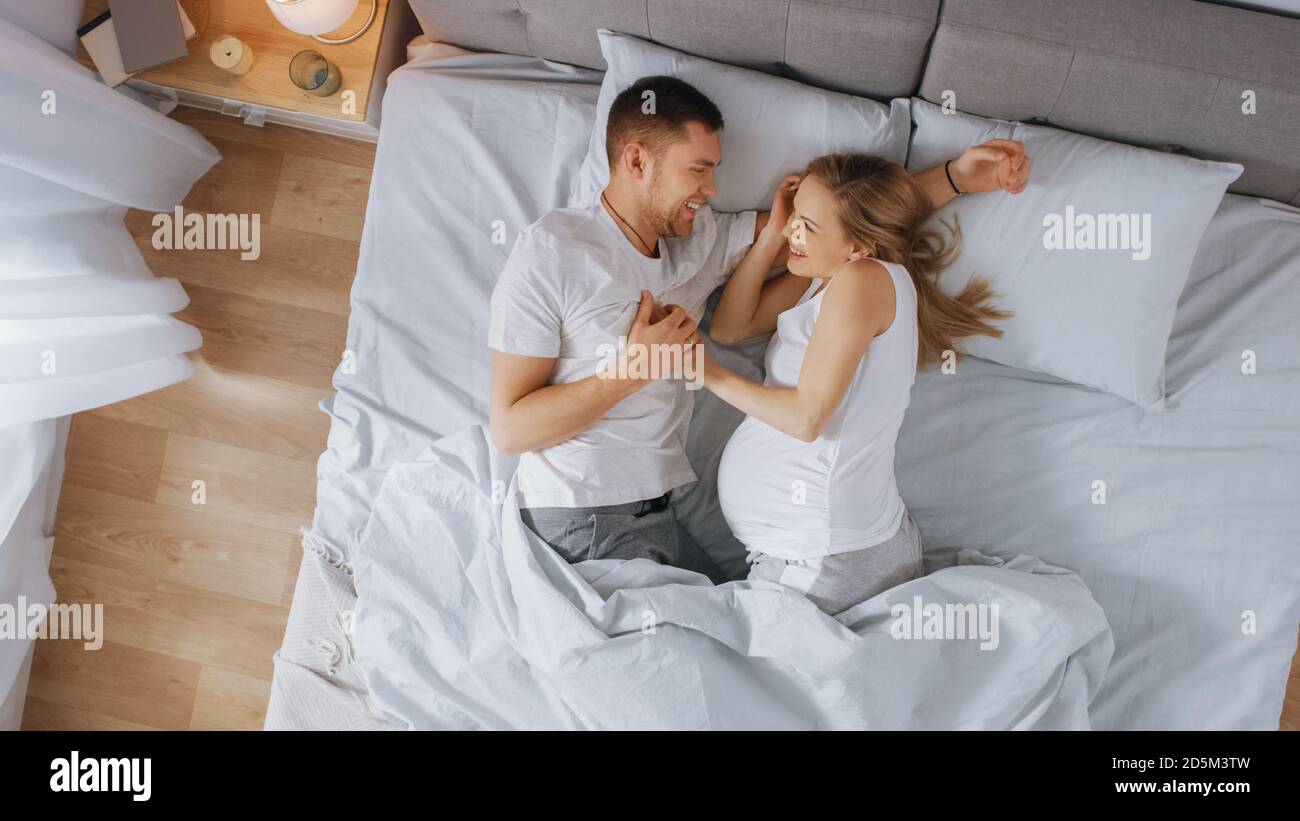 Happy Young Couple Cuddling Together in the Bed, Young Woman is ...