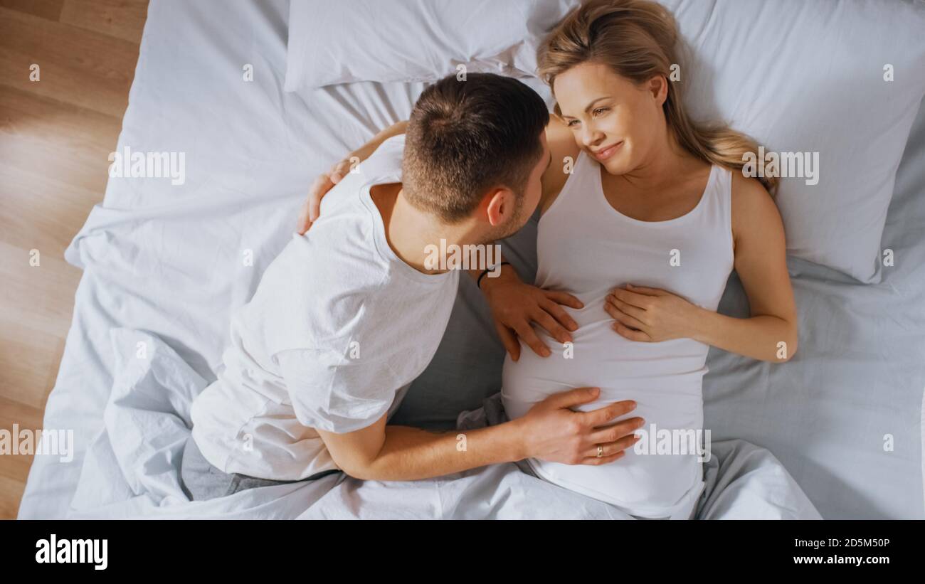 Happy Young Couple Cuddling Together in the Bed, Young Woman is ...
