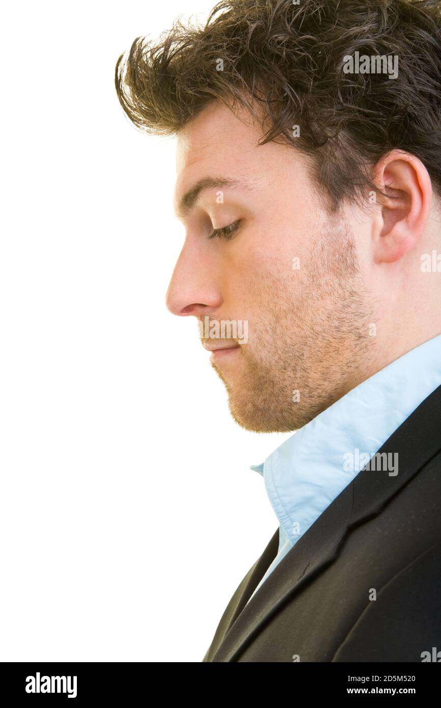 Young man in suit in profile view Stock Photo - Alamy