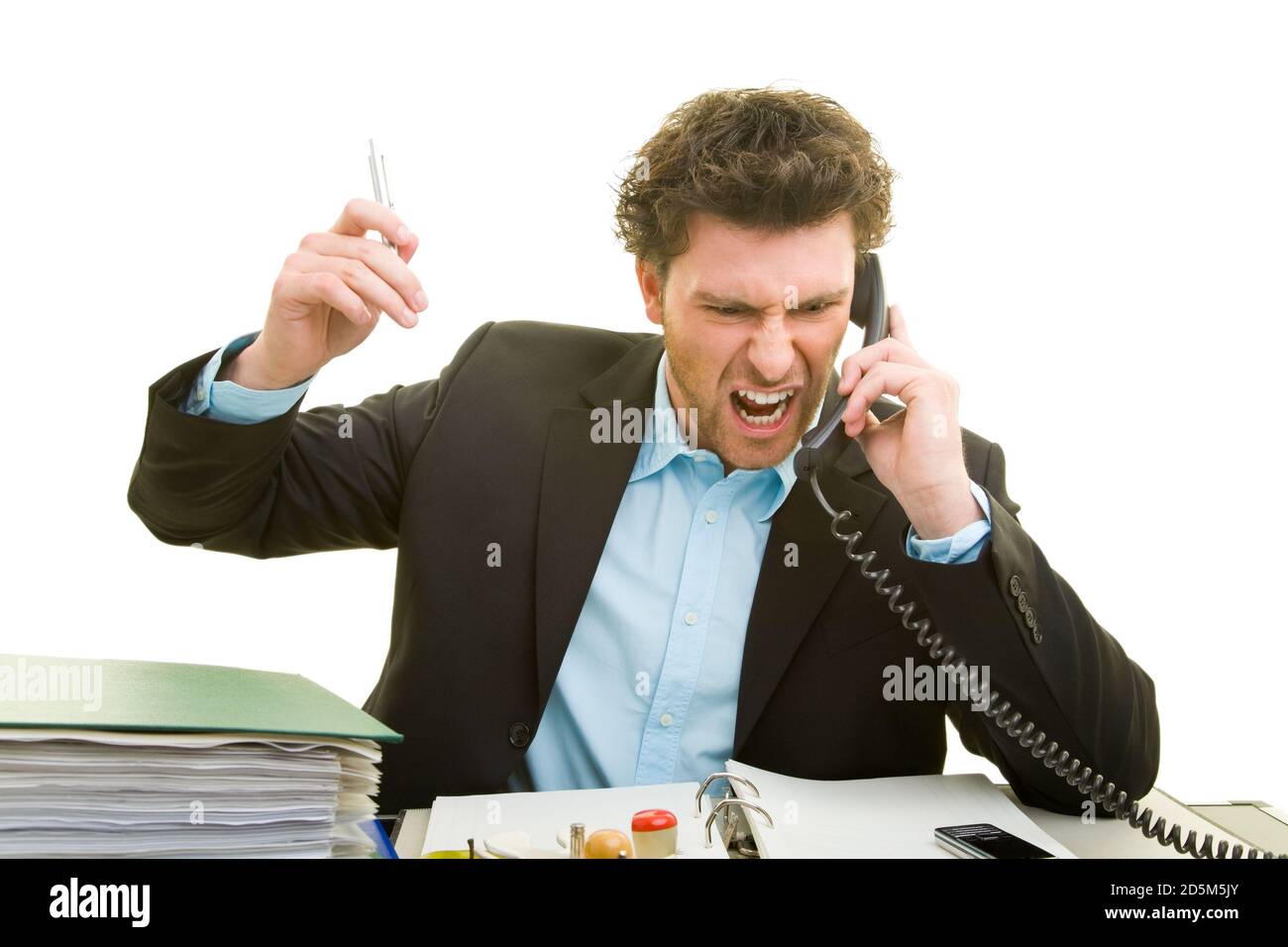 Young man talking on the phone in frustration at his desk Stock Photo ...