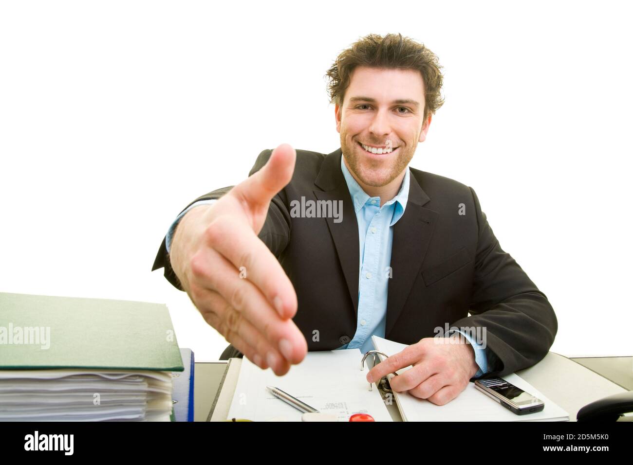 Young man at the desk extends his hand forward Stock Photo - Alamy