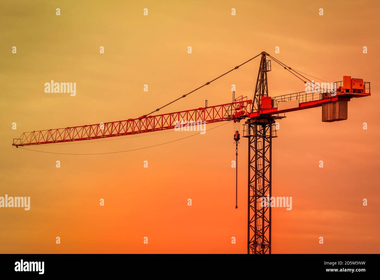 Tower crane on building construction site at sunrise Stock Photo - Alamy