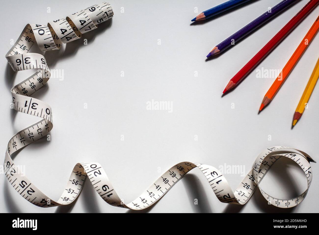 Tape measure & colored pencils education back to school background ...