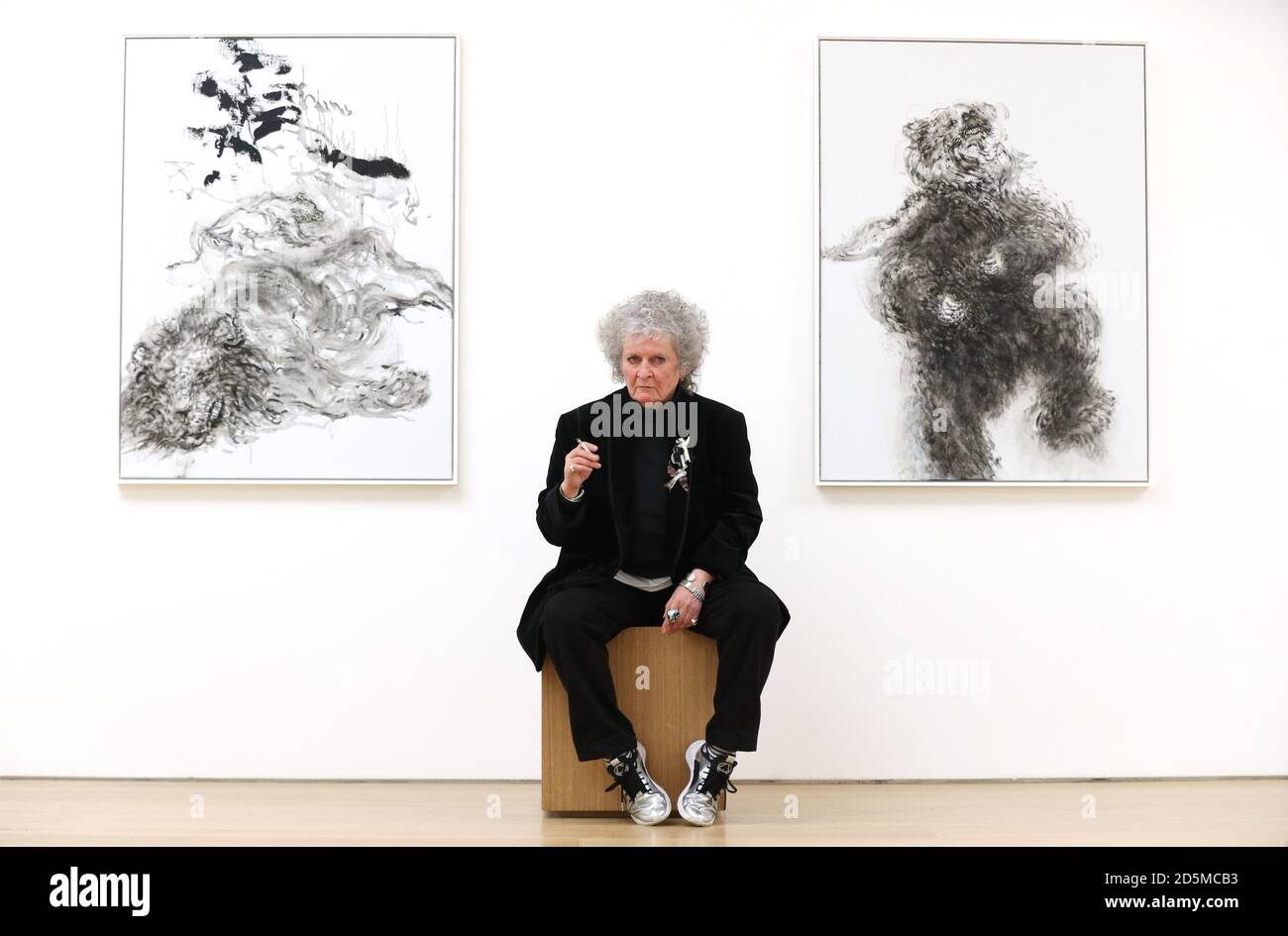 British artist Maggi Hambling sits between her works 'Lion in Enclosure ...