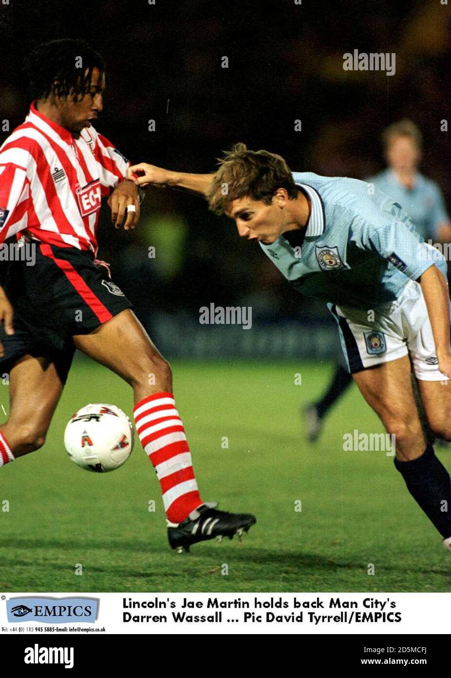 Lincoln's Jae Martin holds back Manchester City's Darren Wassall Stock ...