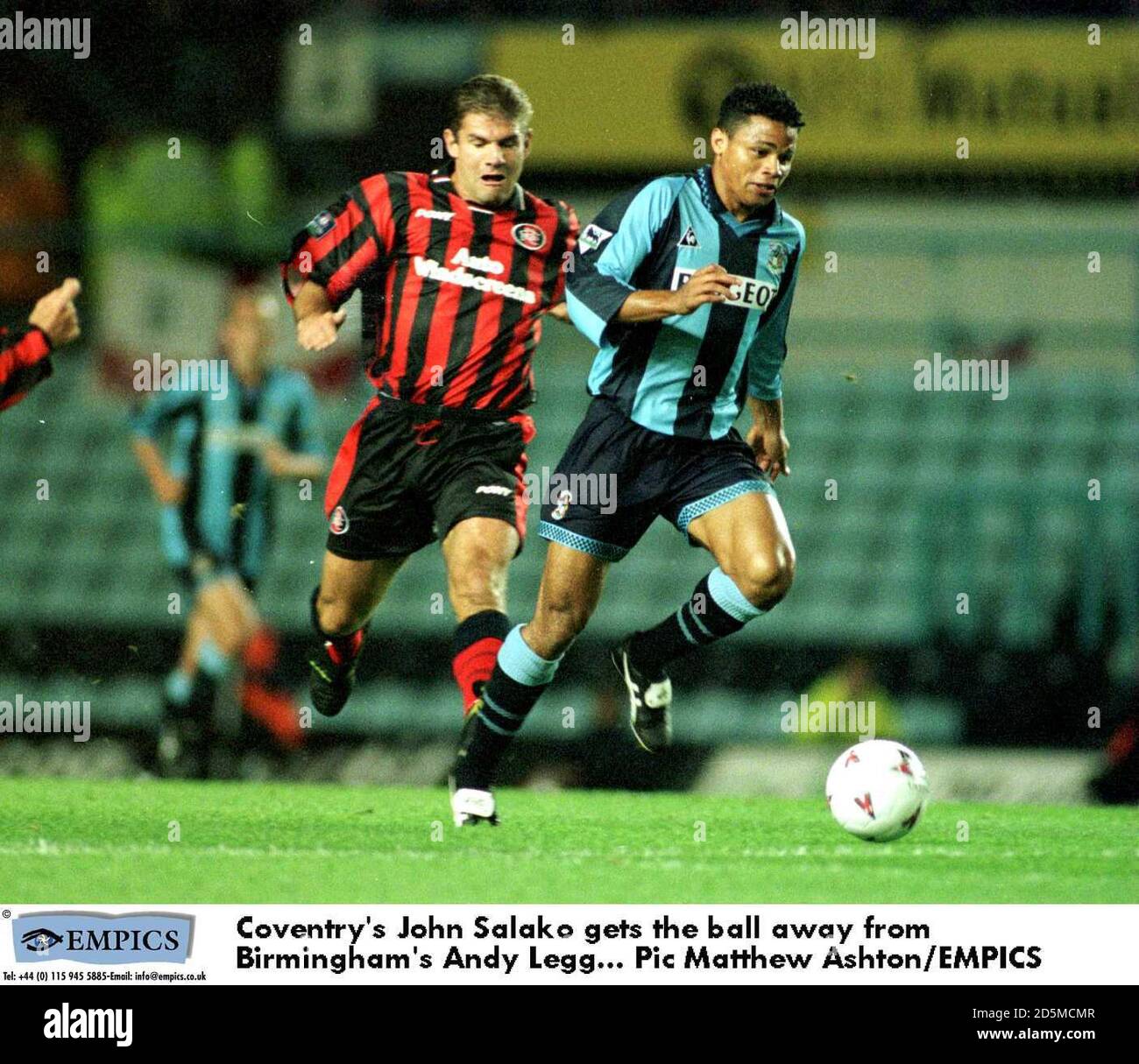 Coventry's John Salako gets the ball away from the Birmingham's defence ...